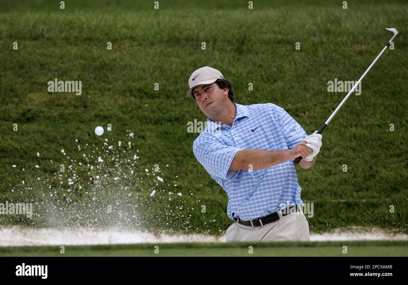 Golfer Chris Couch hits out of a sand trap and onto the fifth green ...
