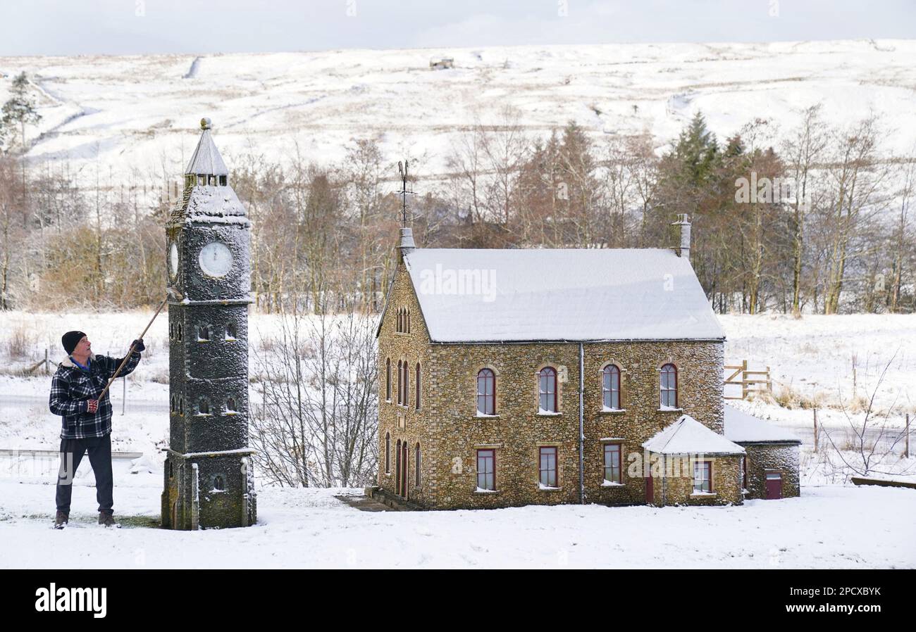 Lawson Robinson, 77, clears snow from his model village he built in his ...