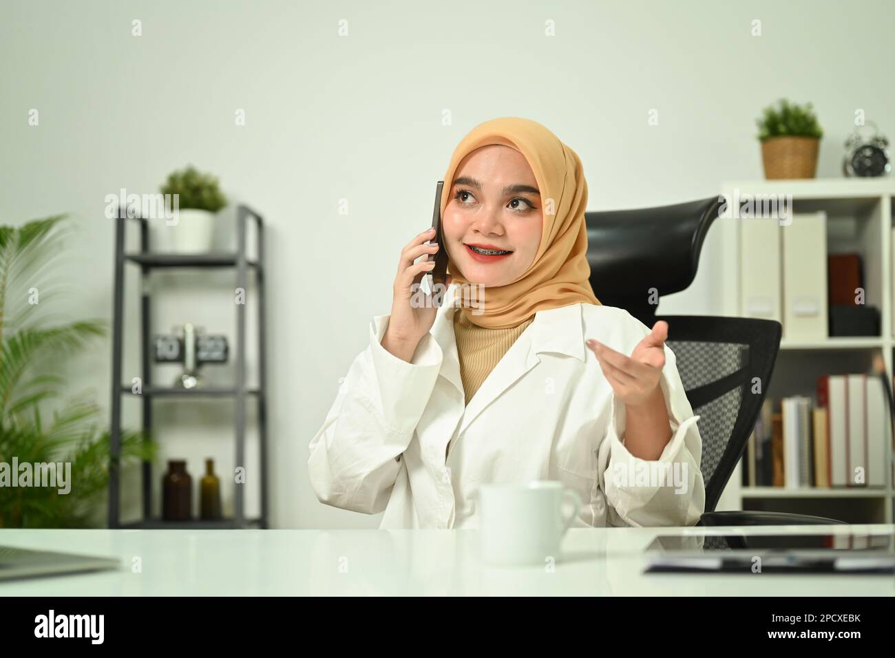 Positive muslim woman corporate CEO having phone conversation ...