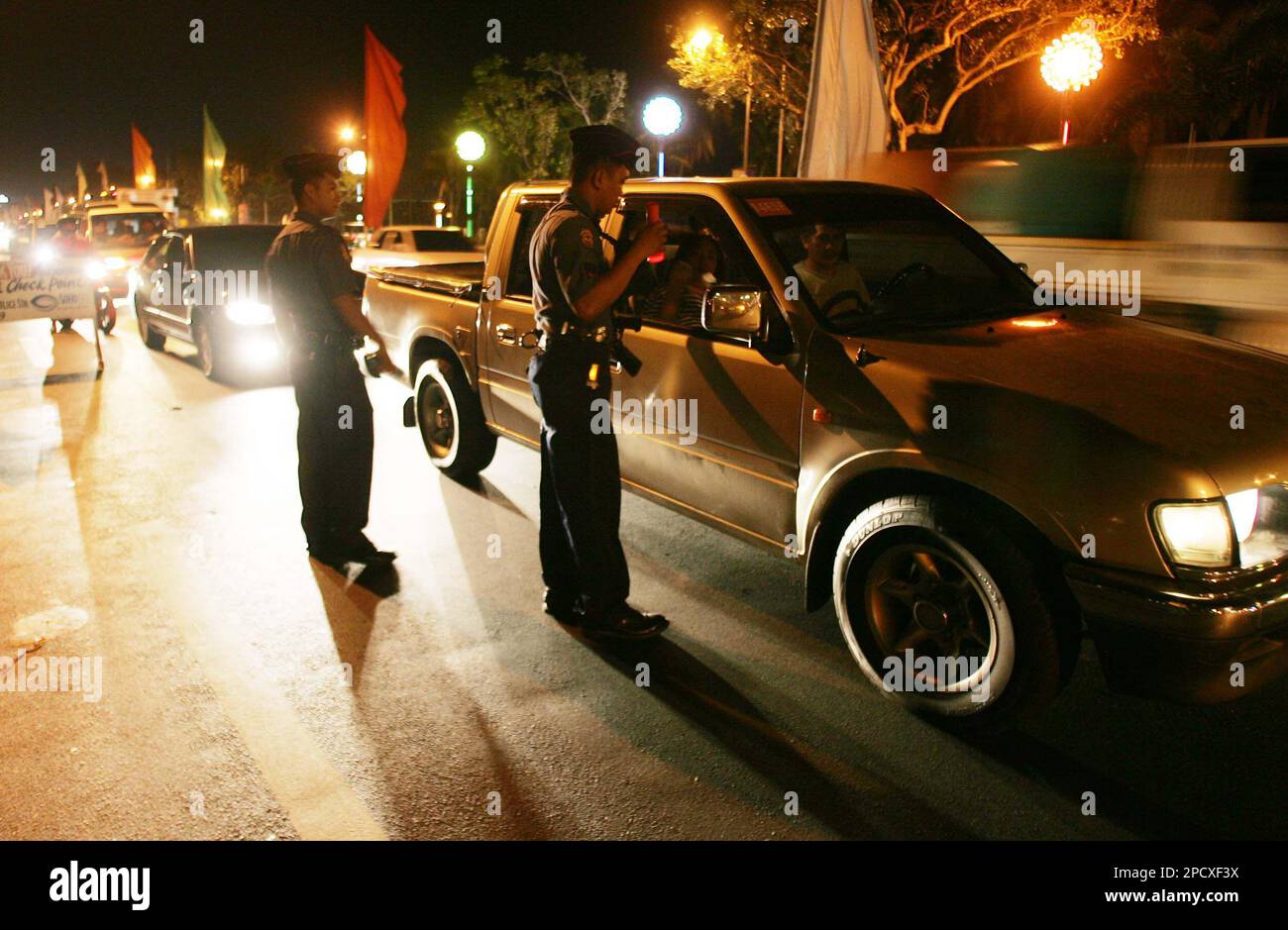 Philippine police man a checkpoint in suburban Manila as the police force went into full alert ...