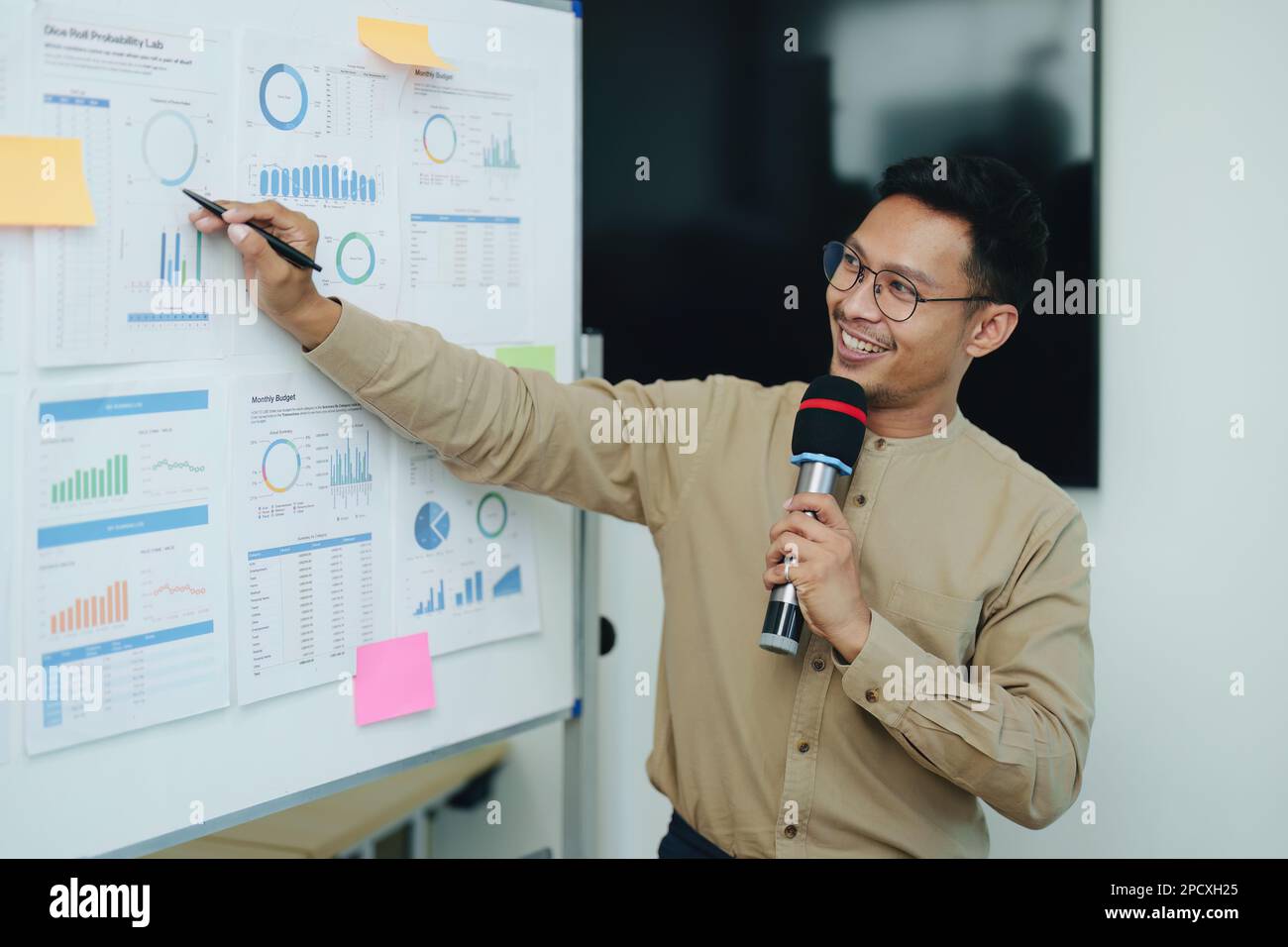 Asian economist or business expert teaches business investment and ...