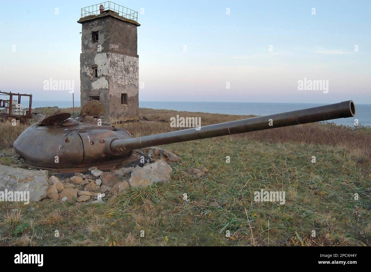 ** FILE ** The turret of an old tank set in the ground as a part of war ...