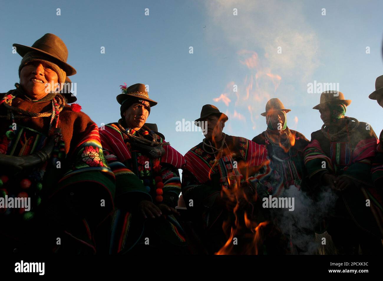 Bolivian Aymaras light a fire to fight cold temperature as they receive ...