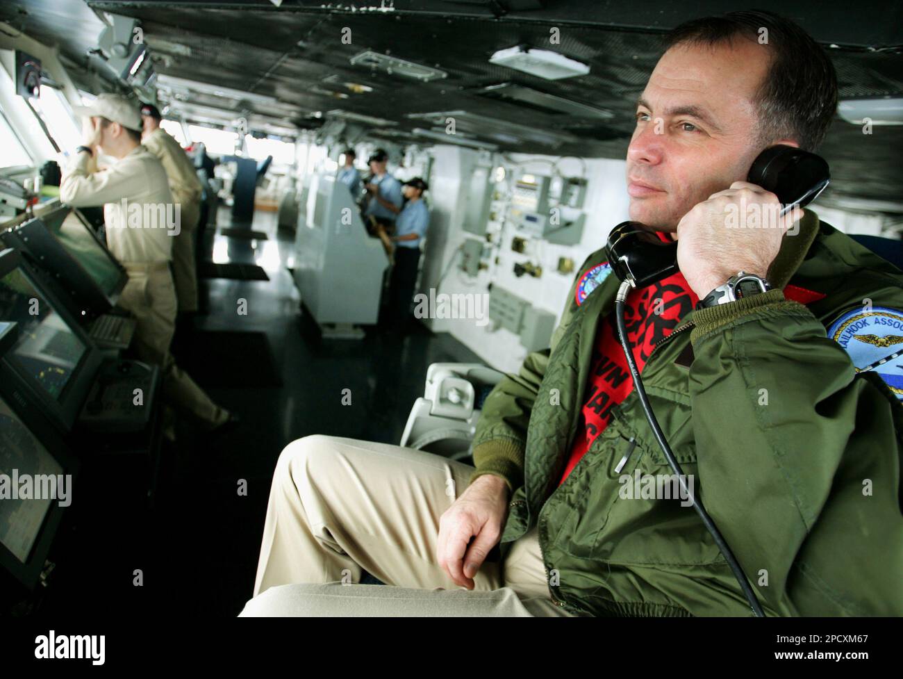 USS Ronald Reagan comanding officer Terry Kraft talks on the phone at ...