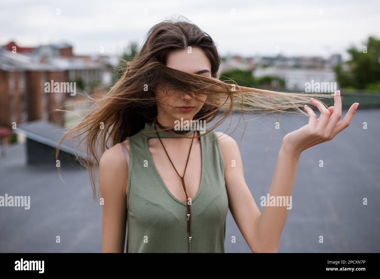 Stranger pretty woman walking on the roof Stock Photo - Alamy