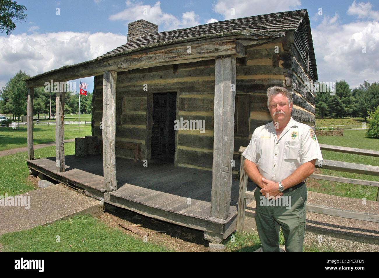 Park manager Mark Halback stands next to a replica of the cabin where ...