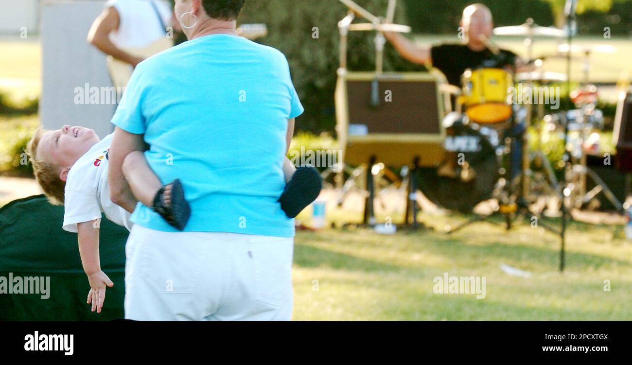 Ethan McDougald, 2, is spun around by his grandmother Pat Croley while ...