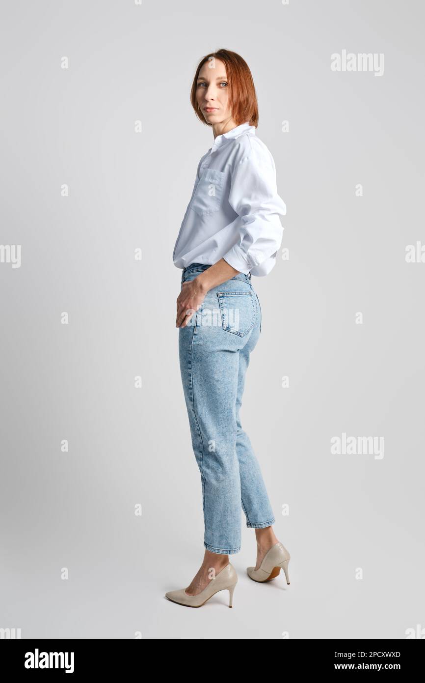 Middle aged redhead woman turning half back Stock Photo - Alamy