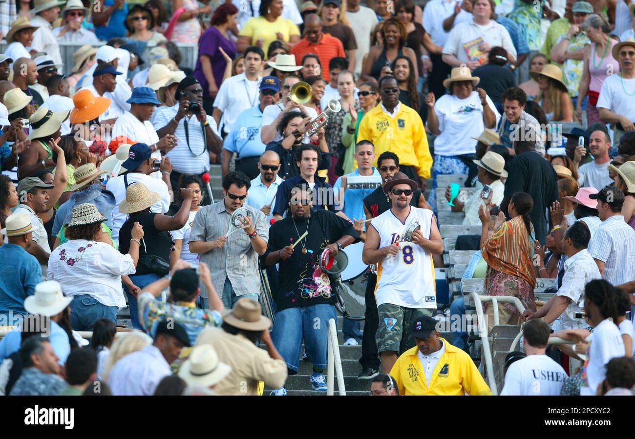 Members of Ozomatli walk through the crowd to the perform onstage ...
