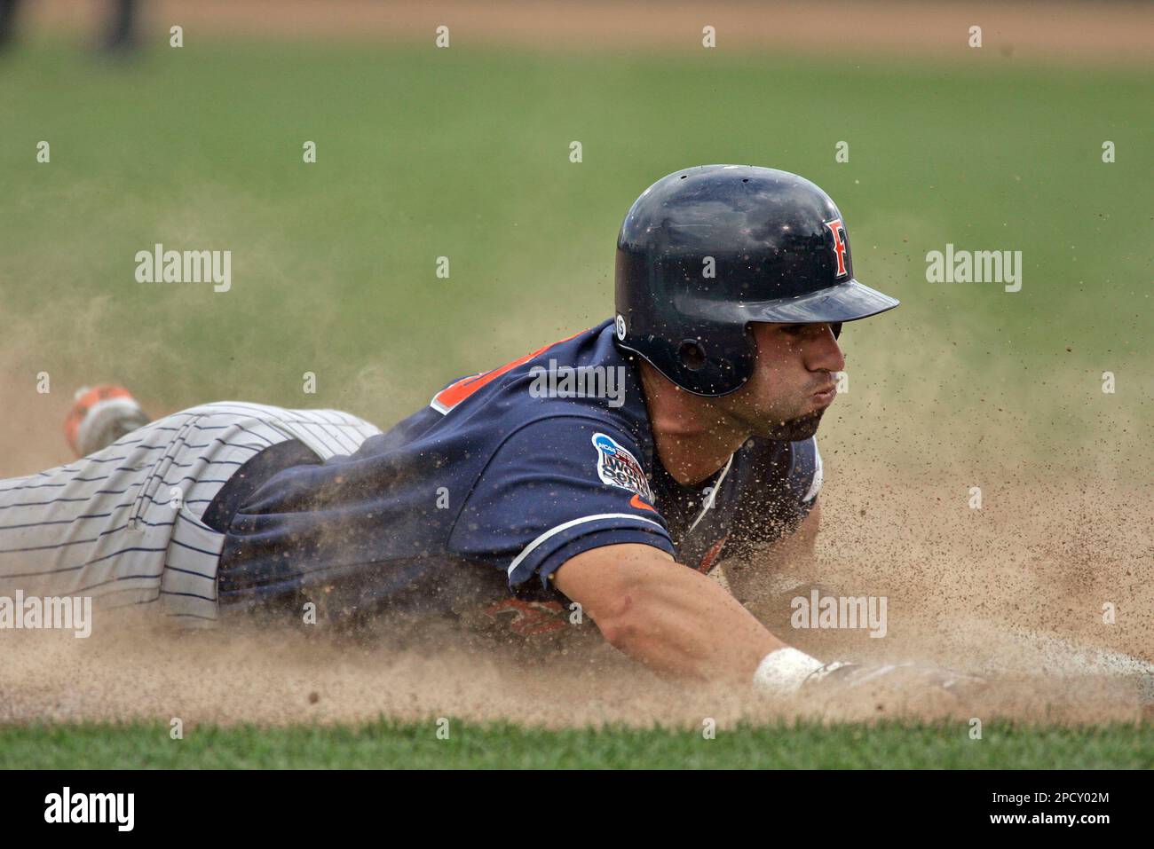 Cal State Fullerton's Brandon Tripp dives to third base after hitting ...
