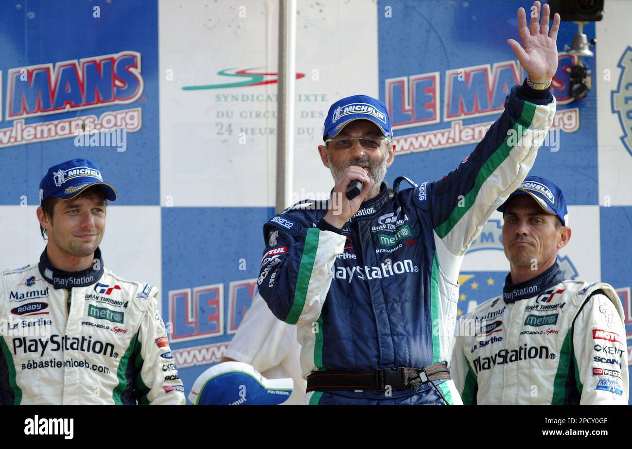 Pescarolo Team Manager Henri Pescarolo of France, center, waves from ...