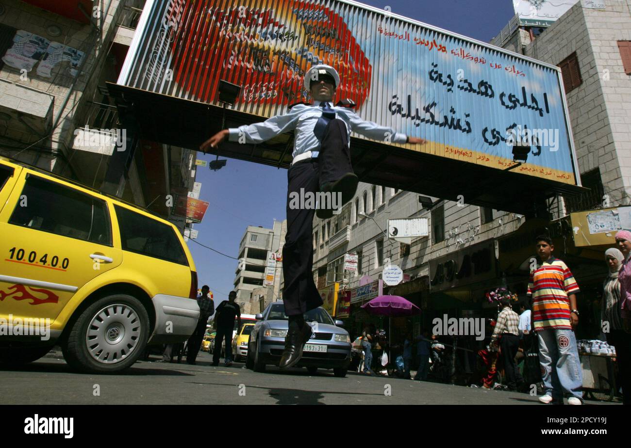 Palestinian traffic police officer Raed Abu Awad, 33, dances as he ...