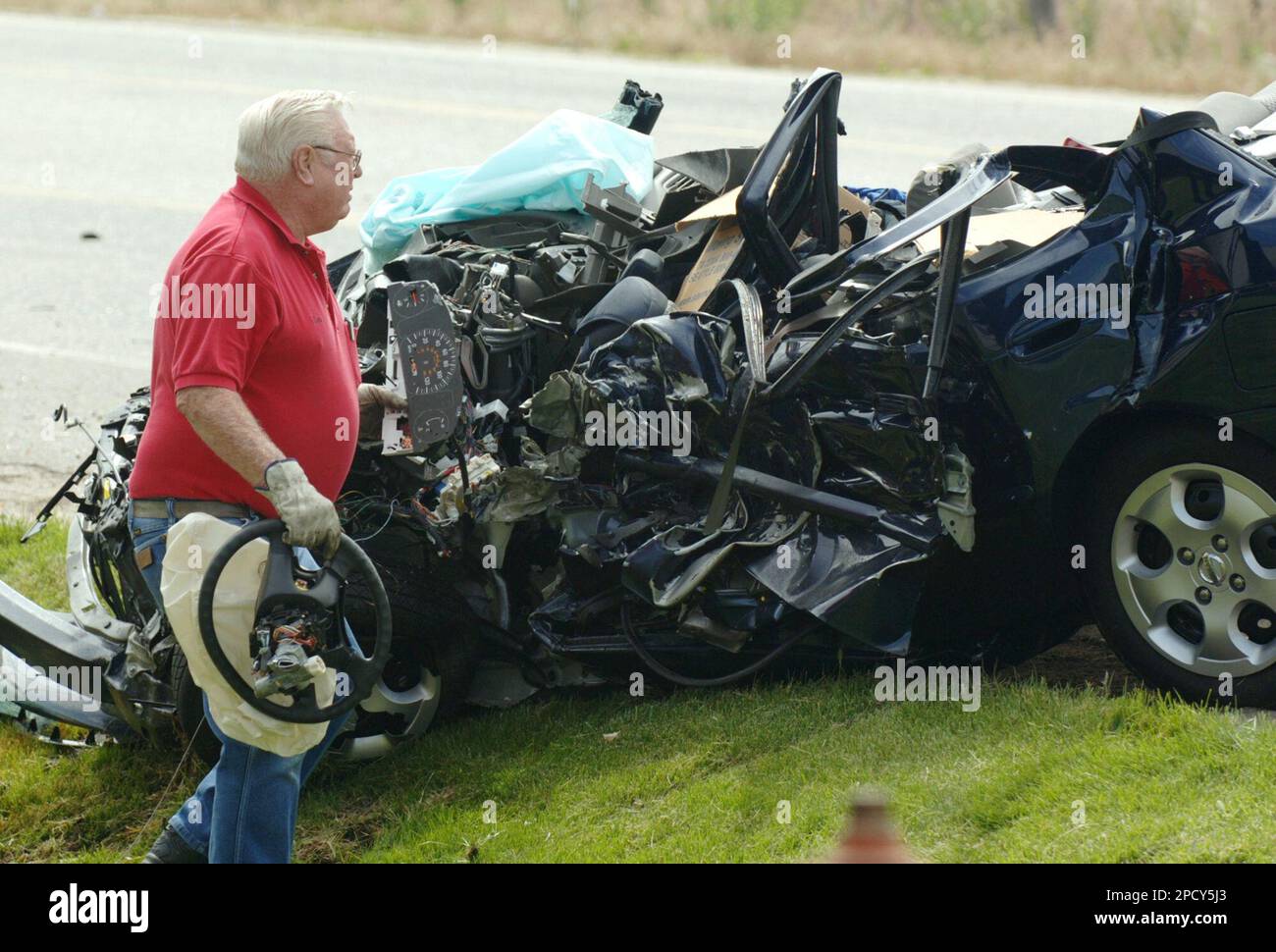 Glen Naylor of Glen's Towing in Boise, Idaho gathers pieces of a ...