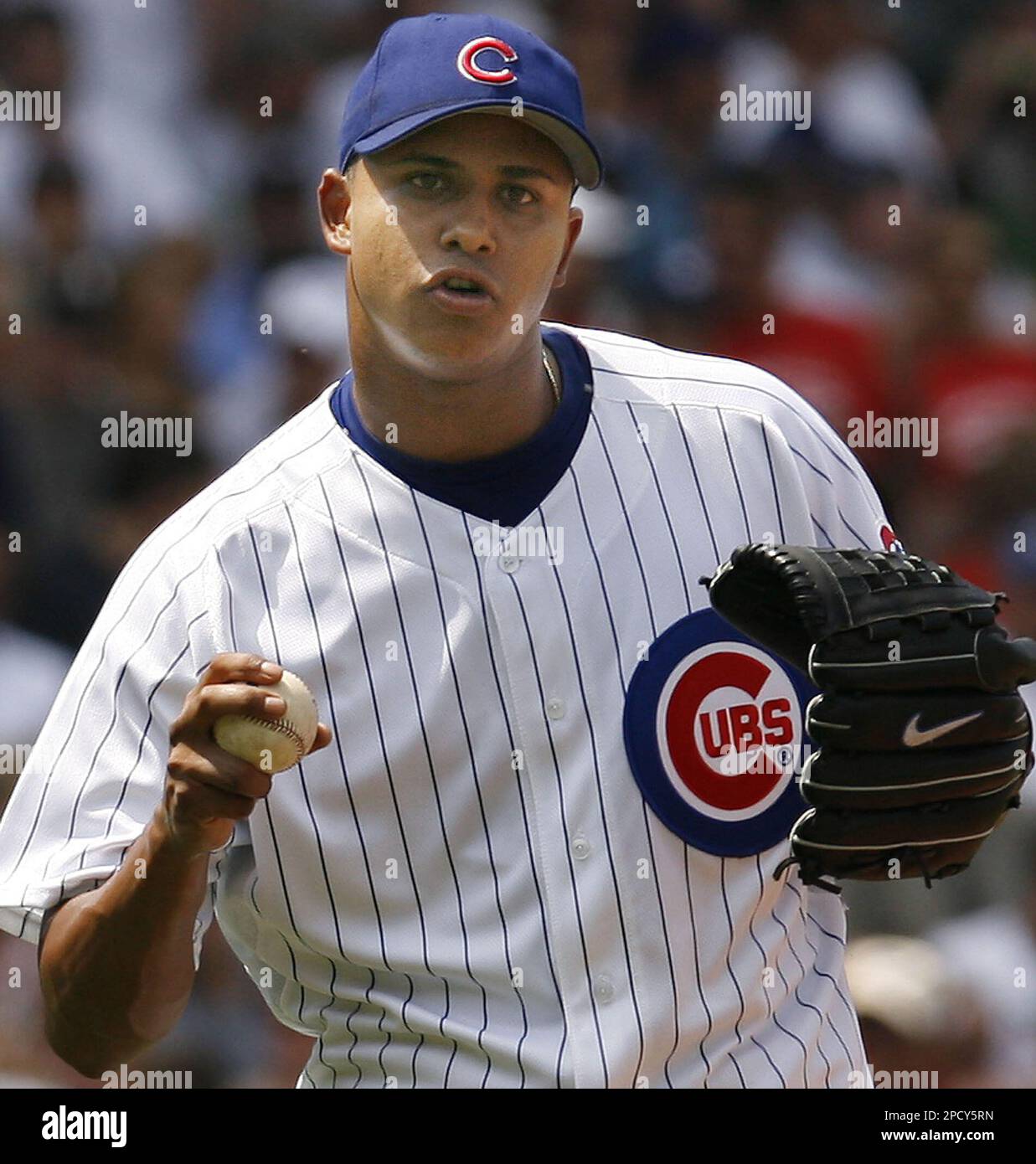 Chicago Cubs pitcher Angel Guzman looks to first base after Detroit ...