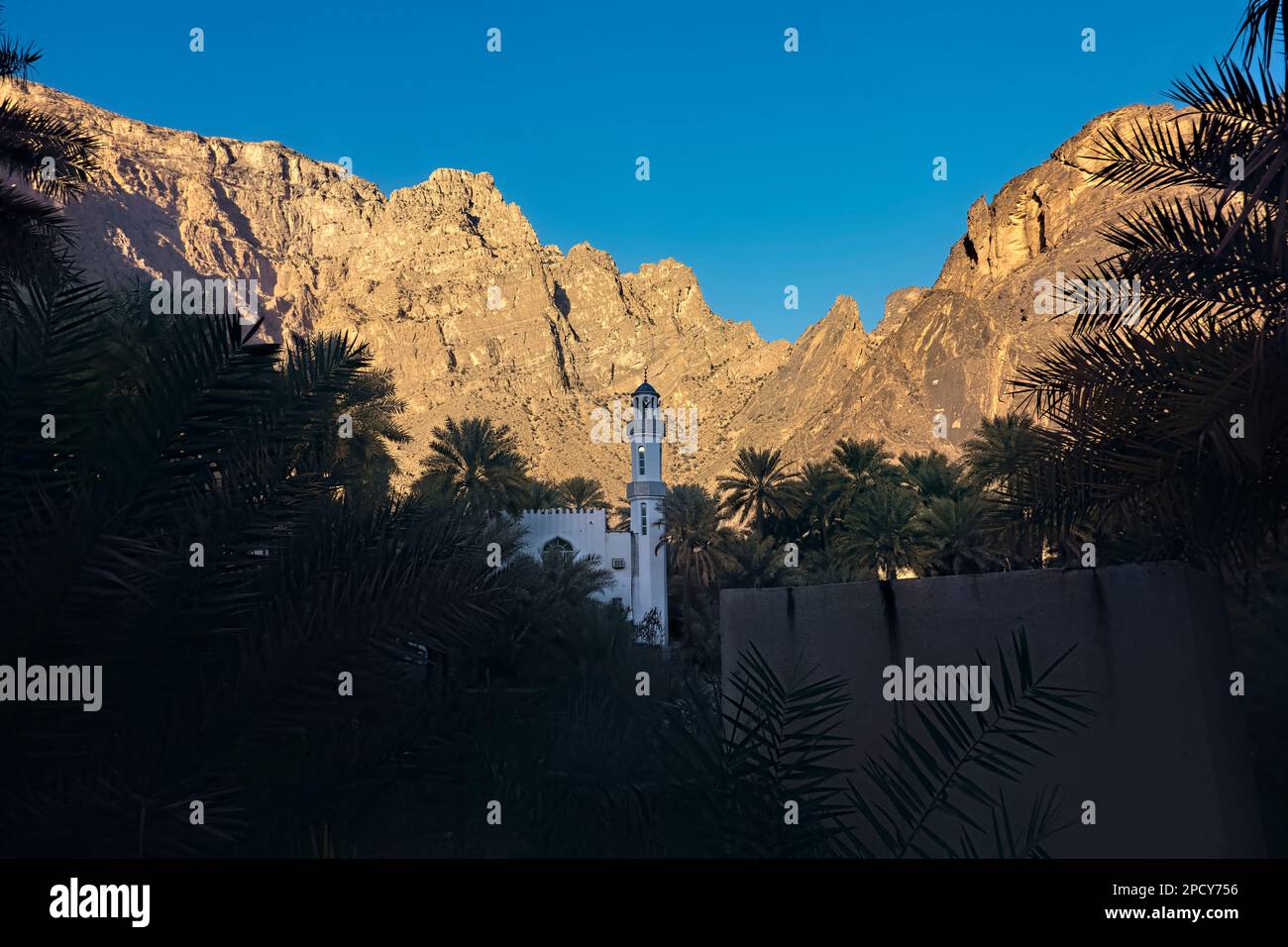 The Western Hajar mountains rise above the mosque in Bald Sayt (Balad ...