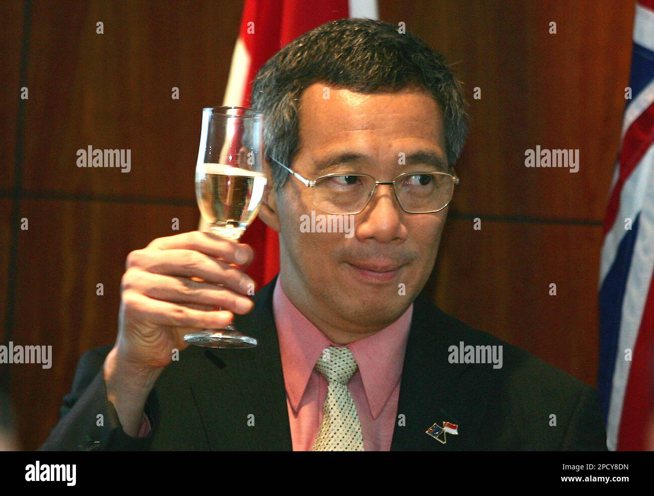 Singapore's Prime Minister Lee Hsien Loong raises his glass to make a ...