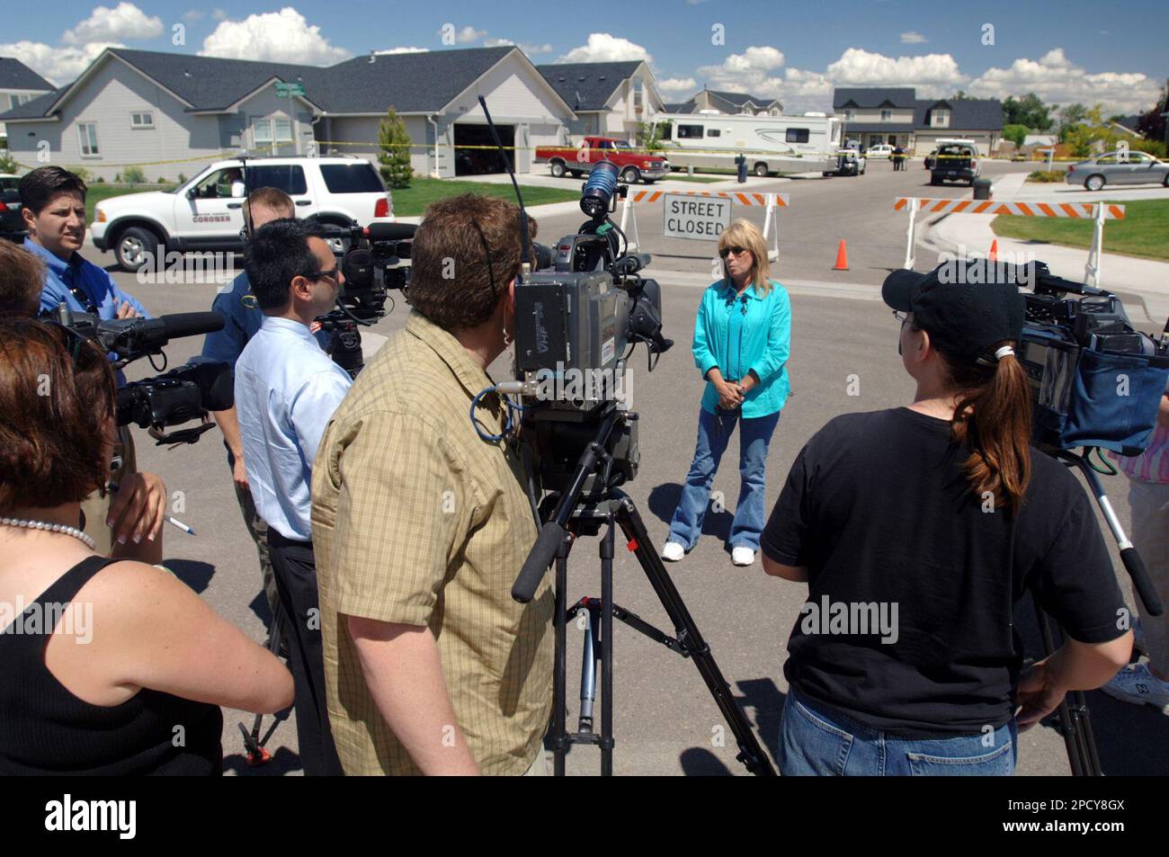 Canyon County Coroner Vicki DeGeus-Morris, background center, addresses ...