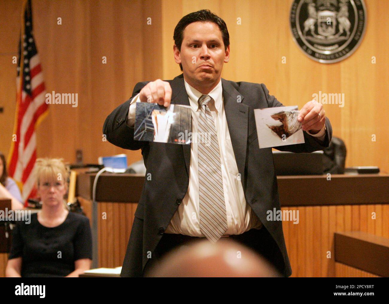 Prosecutor Mark Bilkovic addresses the jury and displays evidence ...