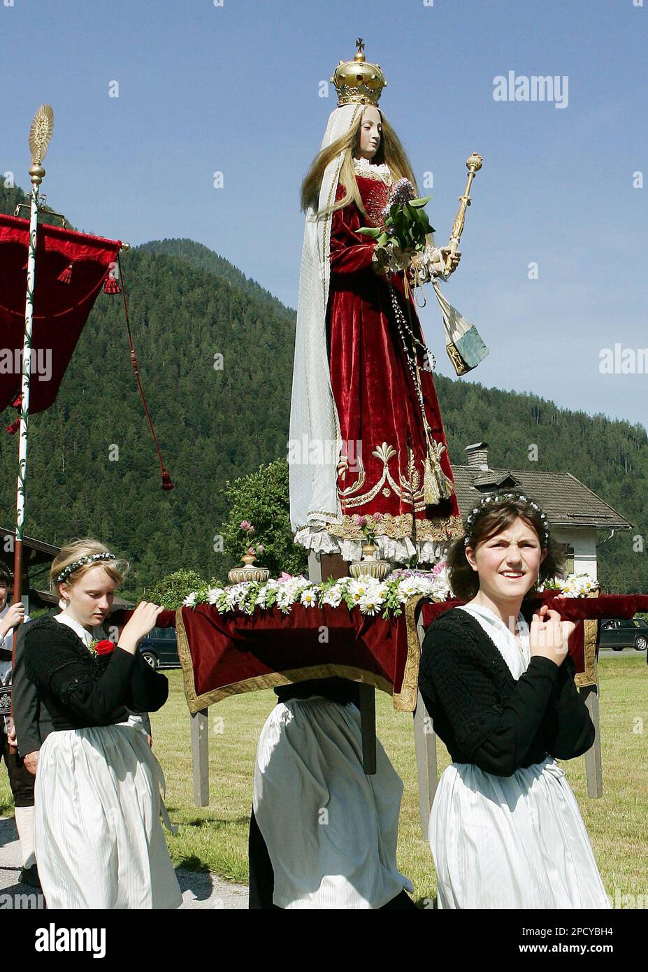 Girls in traditional costumes carry a pieta during a procession marking ...