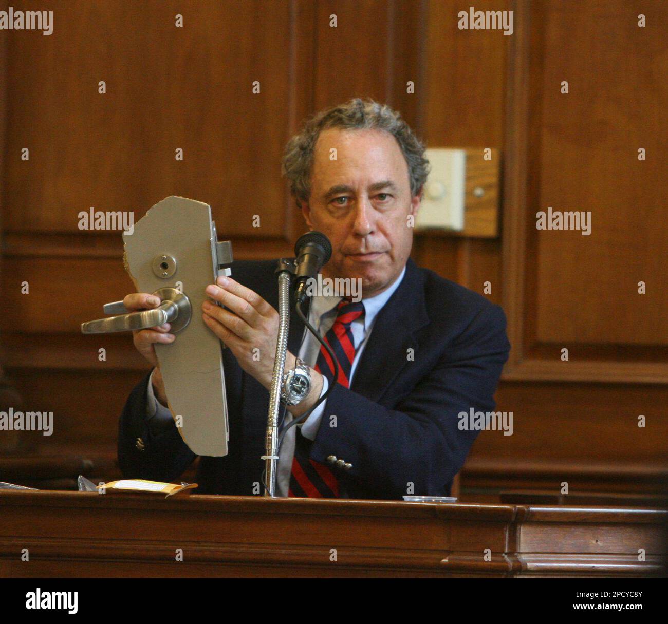 Marc Tobias, identified as a lock expert, displays a lock mechanism ...