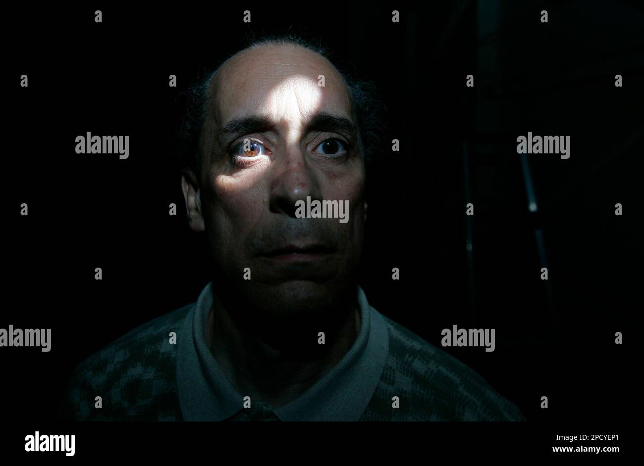 Photographer Clayton Spada is illuminated by a pinhole camera Tuesday ...