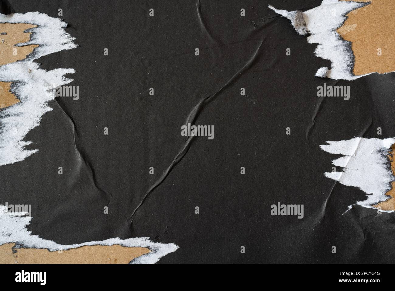 Ripped black paper on cardboard background Stock Photo - Alamy