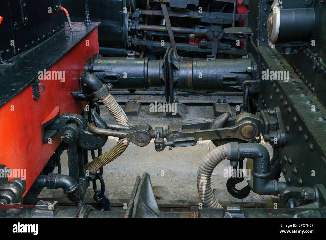 Connection of old trains between wagons in station Stock Photo - Alamy