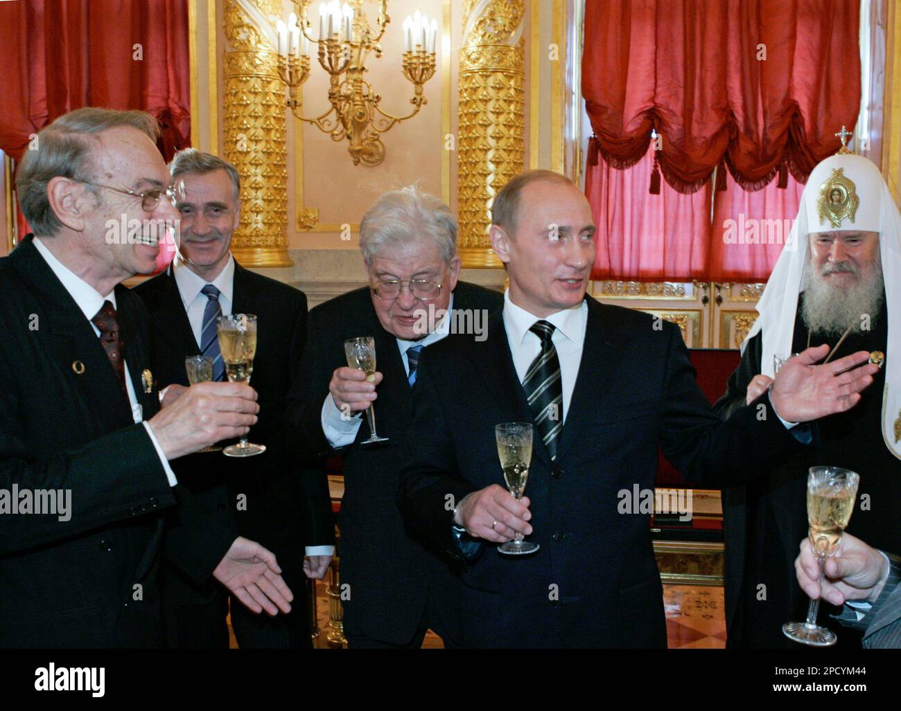 President Vladimir Putin shares a joke with awards' recipients during a ...