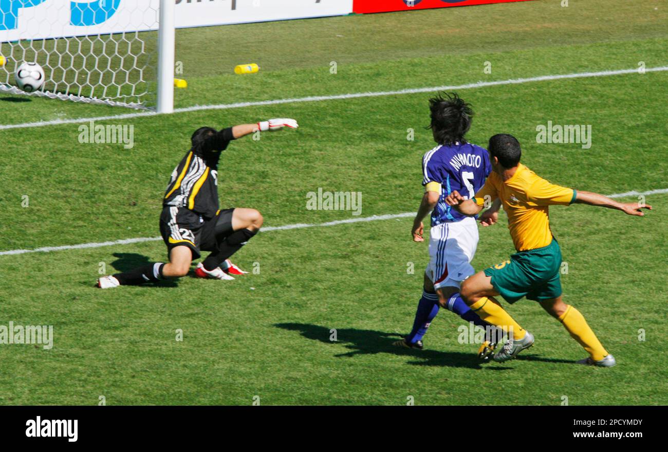 Japan's goal keeper Yoshikatsu Kawaguchi looks back at Australia's John ...