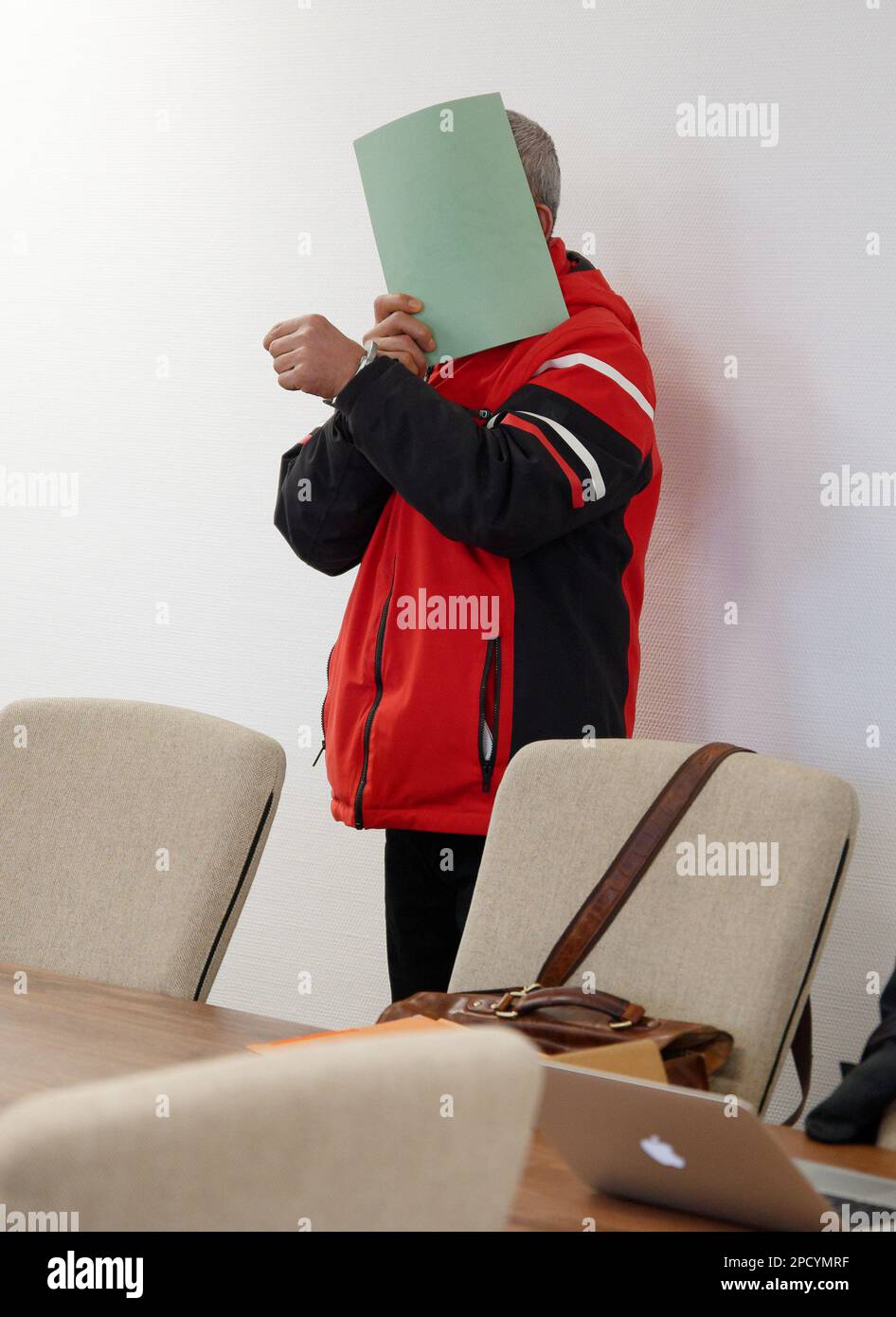 Cologne, Germany. 14th Mar, 2023. The defendant stands in a courtroom in Cologne more than 35 ...