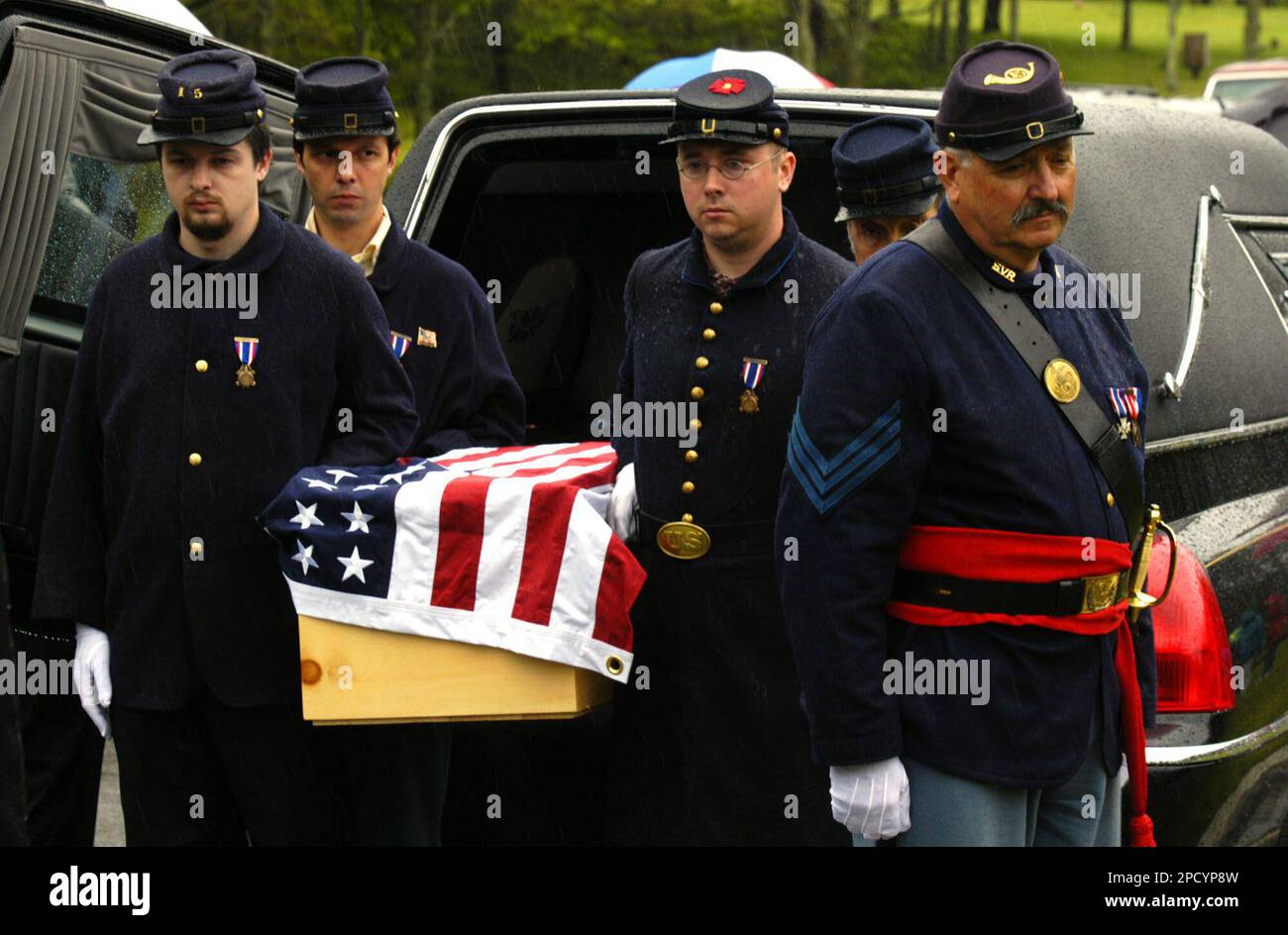Civil War reenactors carry a coffin during interment ceremonies for the ...