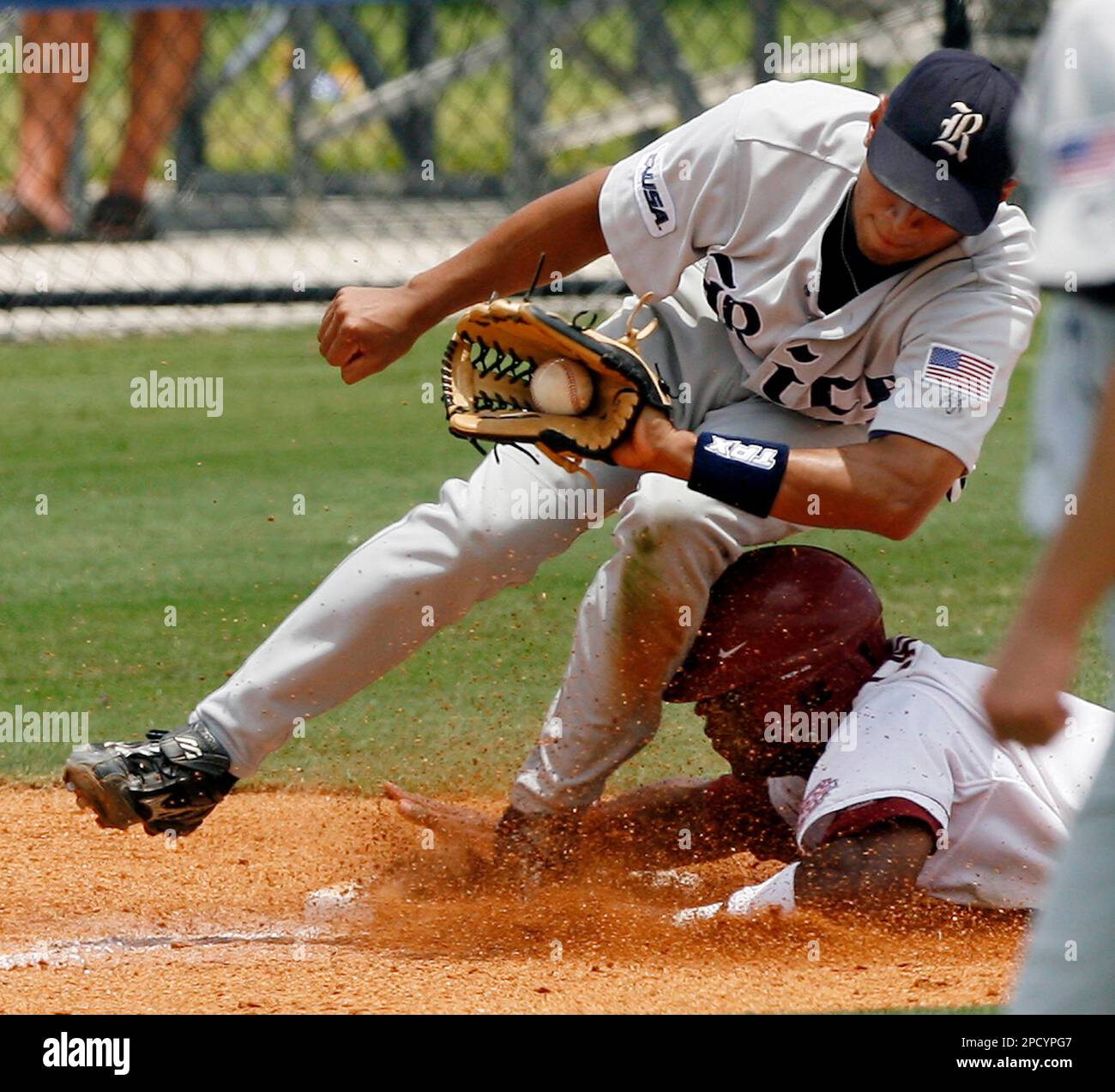 Oklahoma's Chuckie Caufield slides under Rice third baseman Josh ...