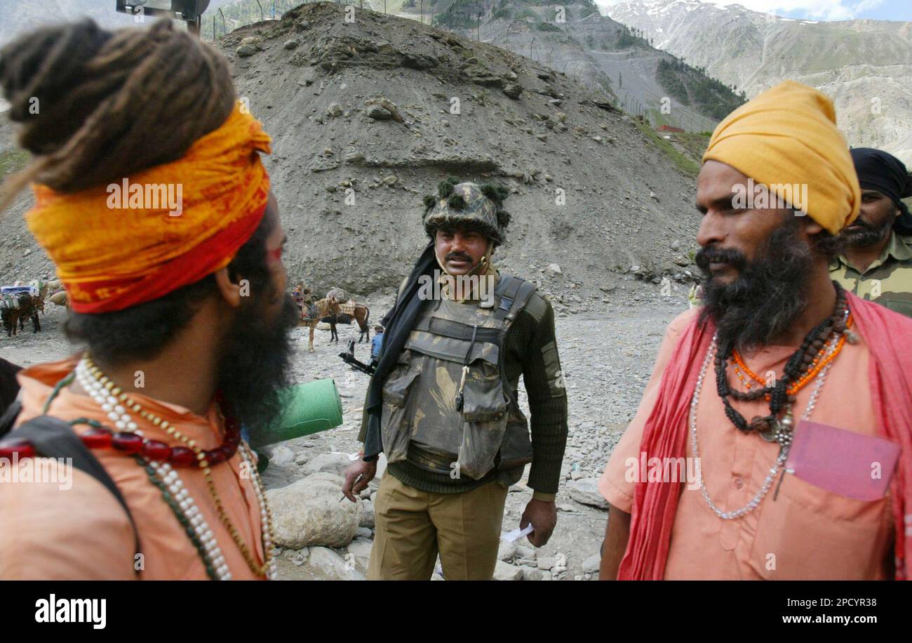 An Indian soldier, center, talks to Hindu holy men on their way to the ...