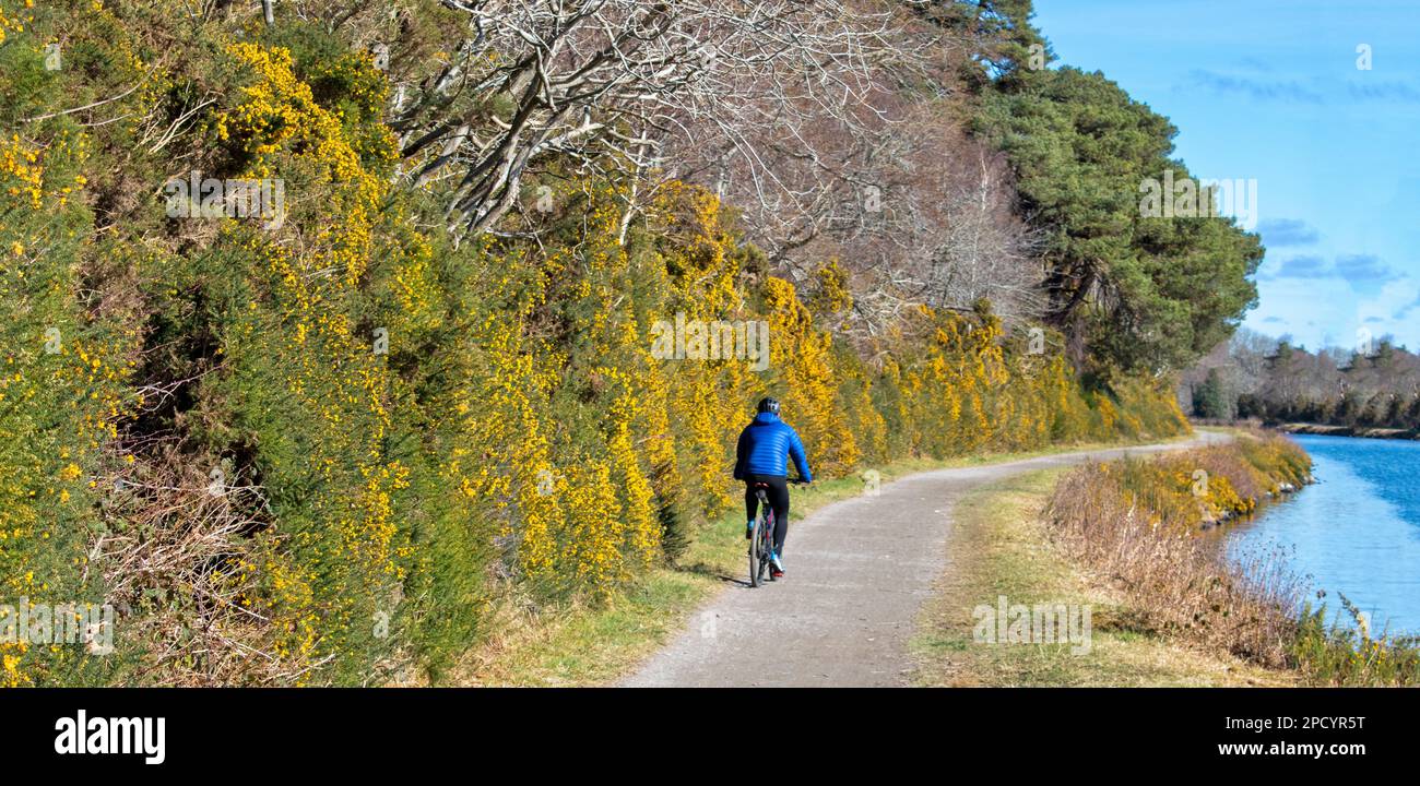 Caledonian Canal Inverness Scotland blue sky and sunshine a cyclist on ...
