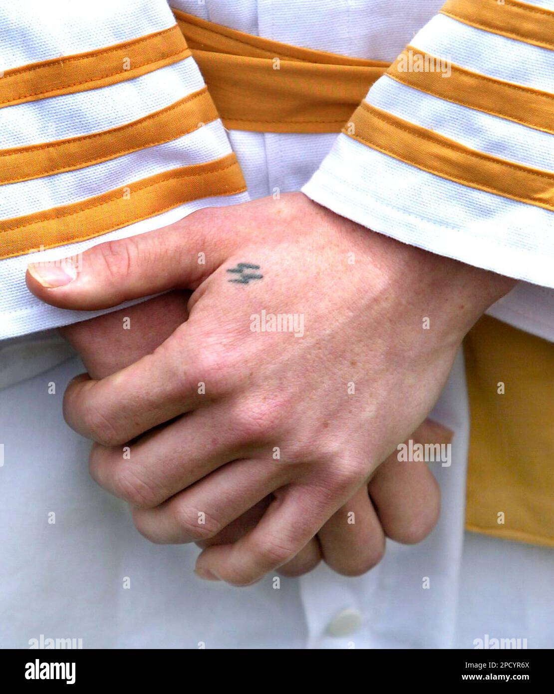 A member of the Ku Klux Klan bears the double lightning bolt symbol ...