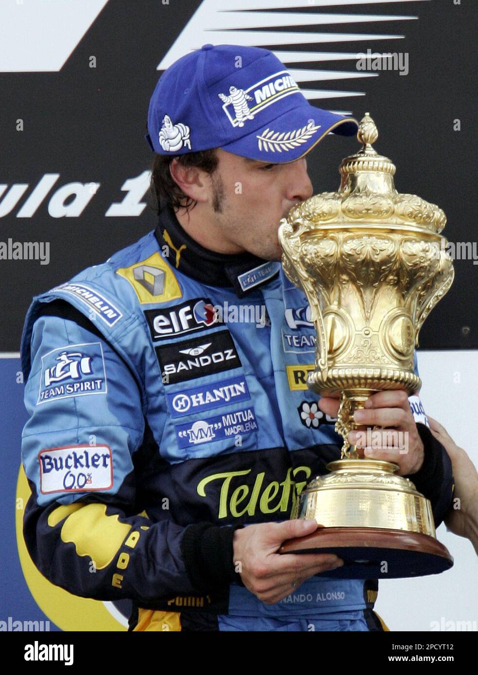 Defending Formula One champion Fernando Alonso of Renault kisses his ...