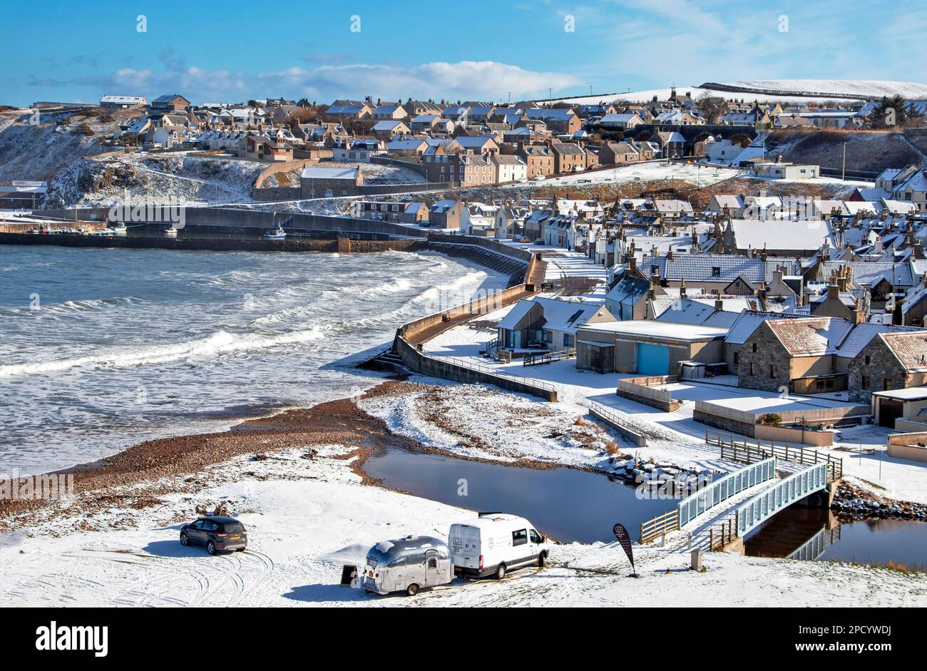 Cullen Bay Moray Scotland a blue sky over snow covered houses and the ...