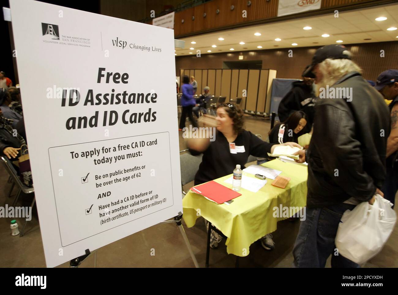 A volunteer points out directions to a homeless man seeking an ...