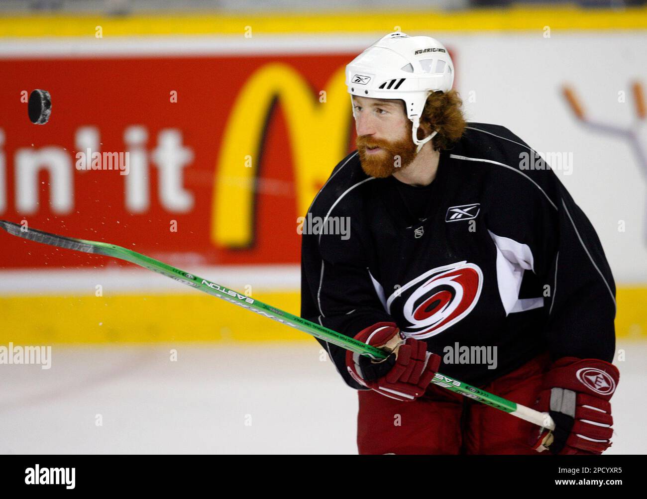 Carolina Hurricanes defenceman Mike Commodore bounces a puck off his ...