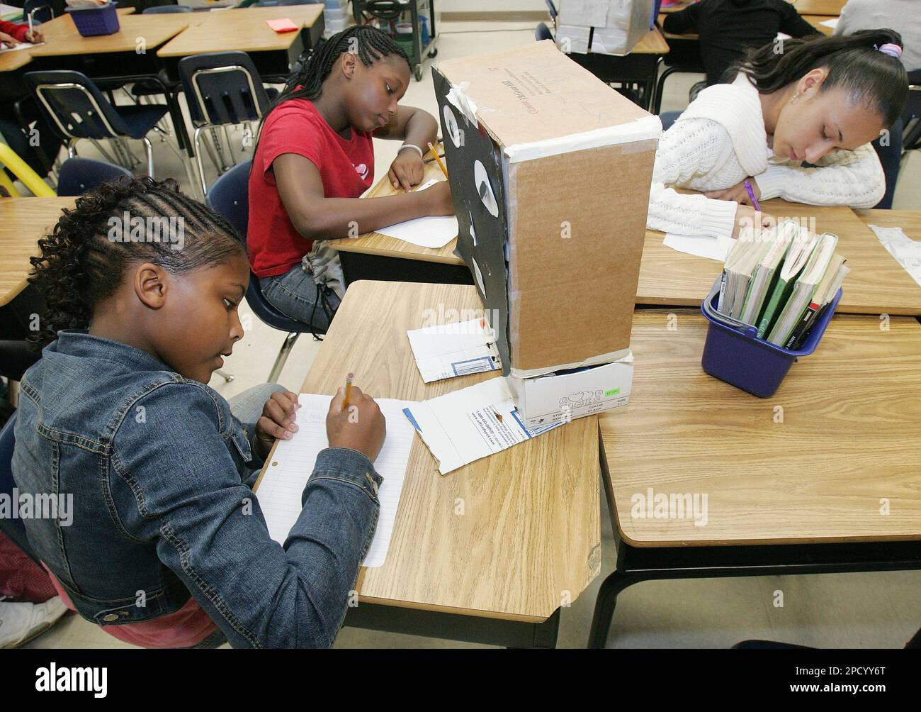 Daija Lee, left, Ashley McClendon, and Fatina Sanchez, right, work on a ...