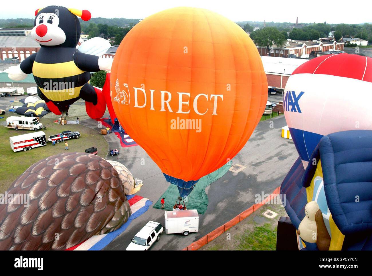 Workers inflate hot-air balloons tethered at the Eastern States ...