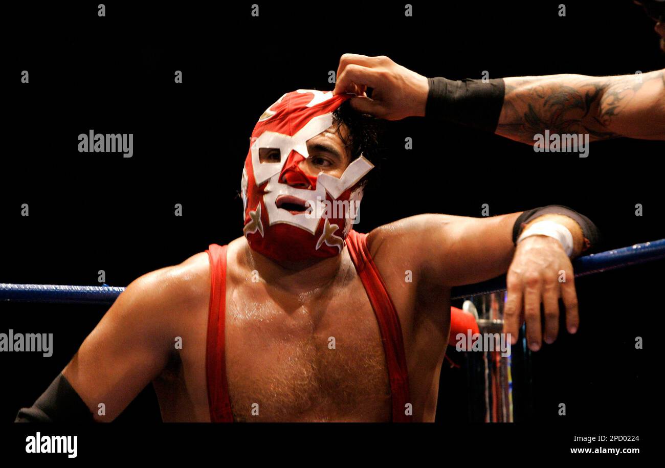 A wrestler adjusts the ripped mask of the well-known Mexican lucha ...