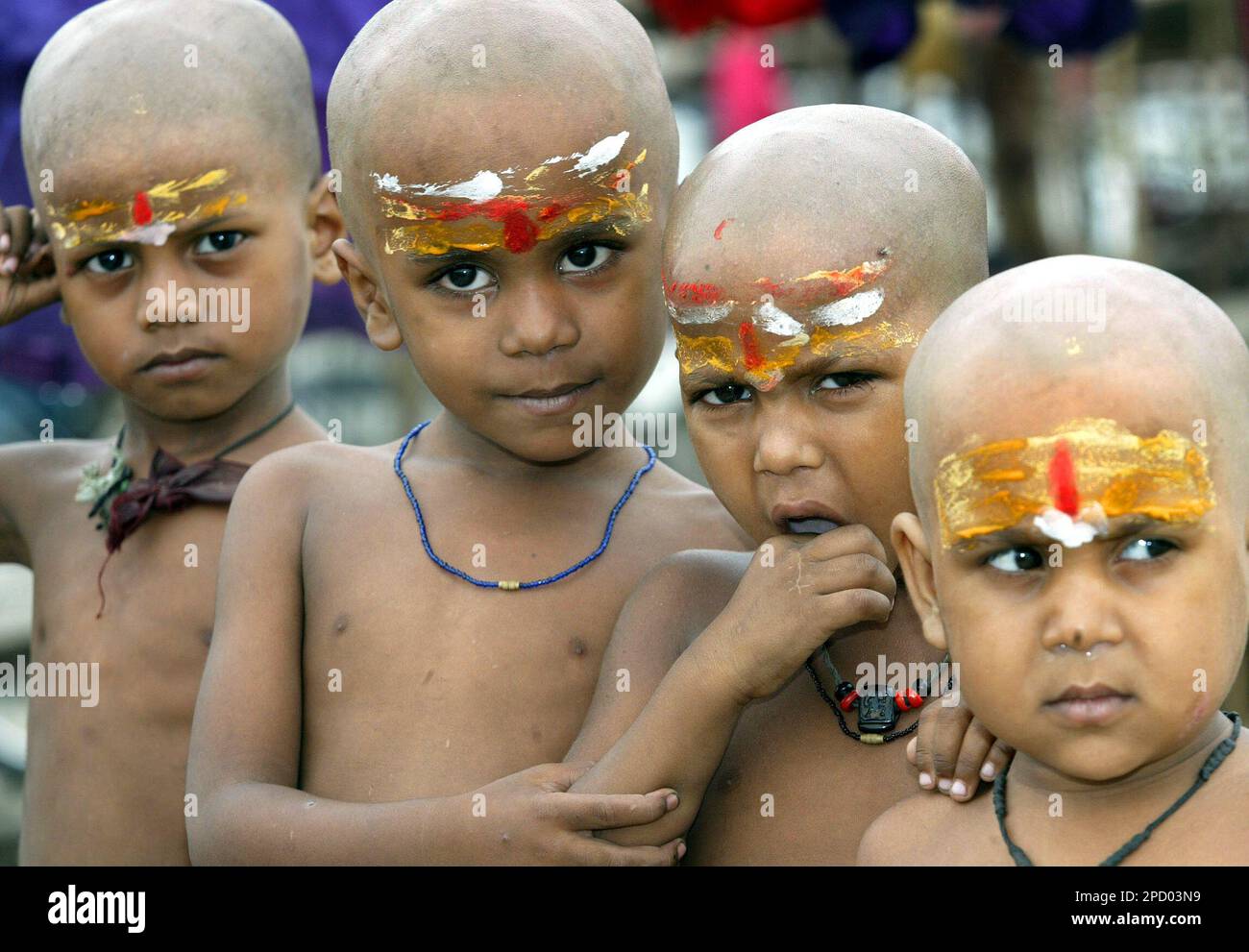 Children look on after a Mundan or head tonsured ceremony, on the bank ...