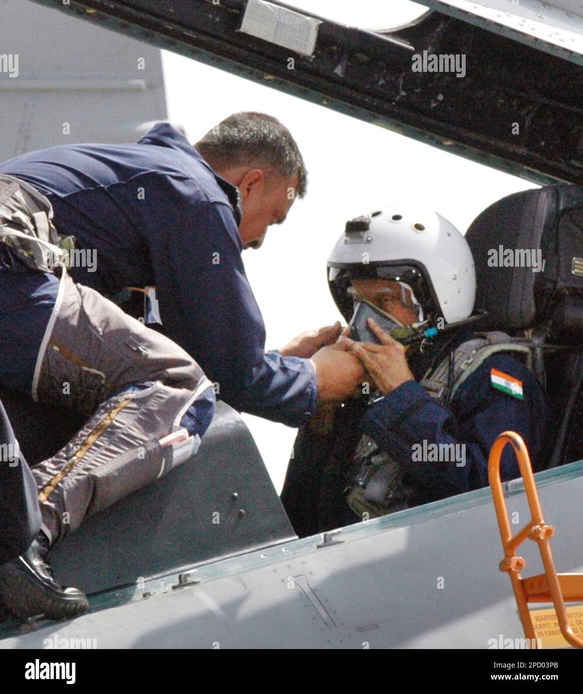 An Indian air force personnel assists Indian President A.P.J. Abdul ...