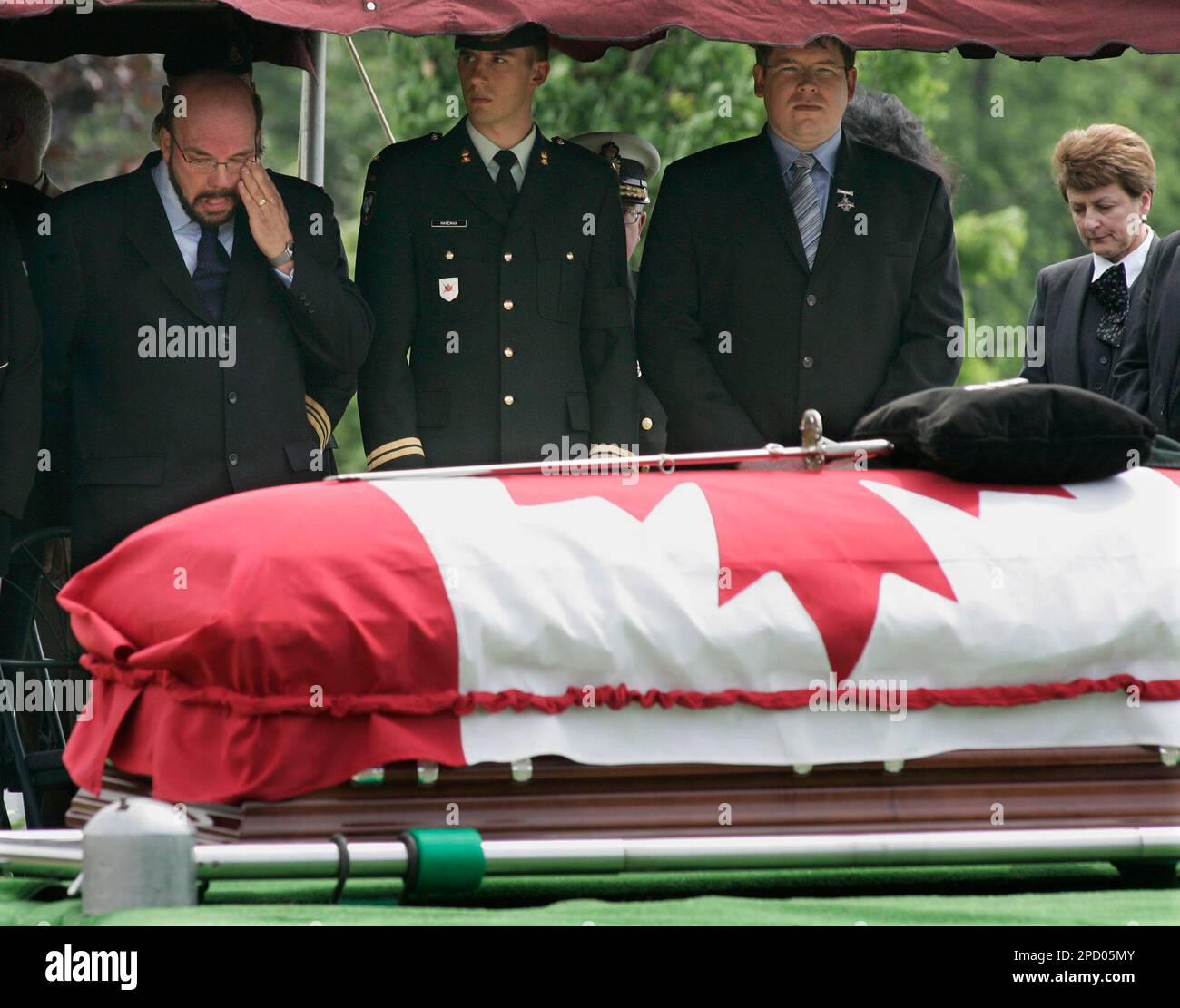 Tim Goddard father of Capt. Nichola Goddard wipes away a tear as he and ...