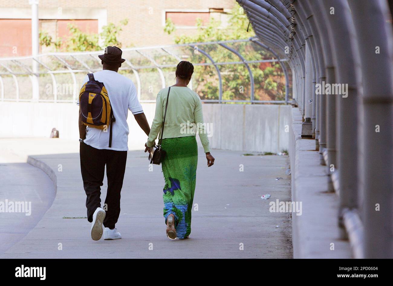 A couple walks hand in hand across the new Forsyth Street bridge near ...
