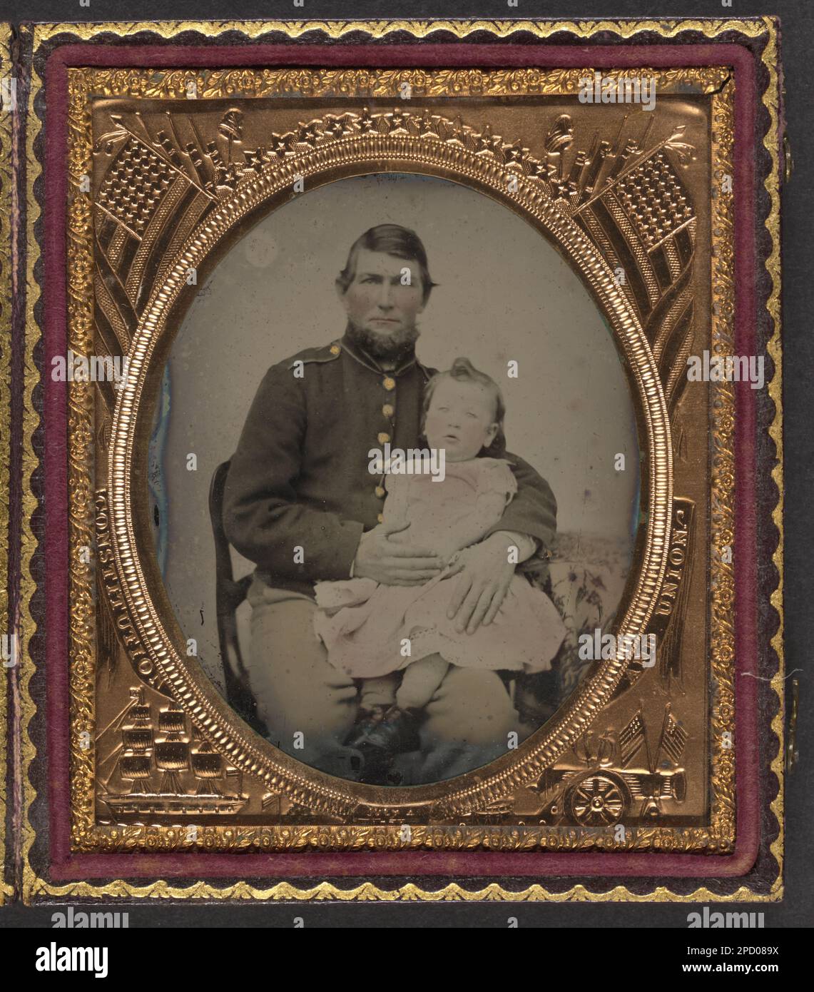 Unidentified soldier in Union uniform holding a young child in his lap ...