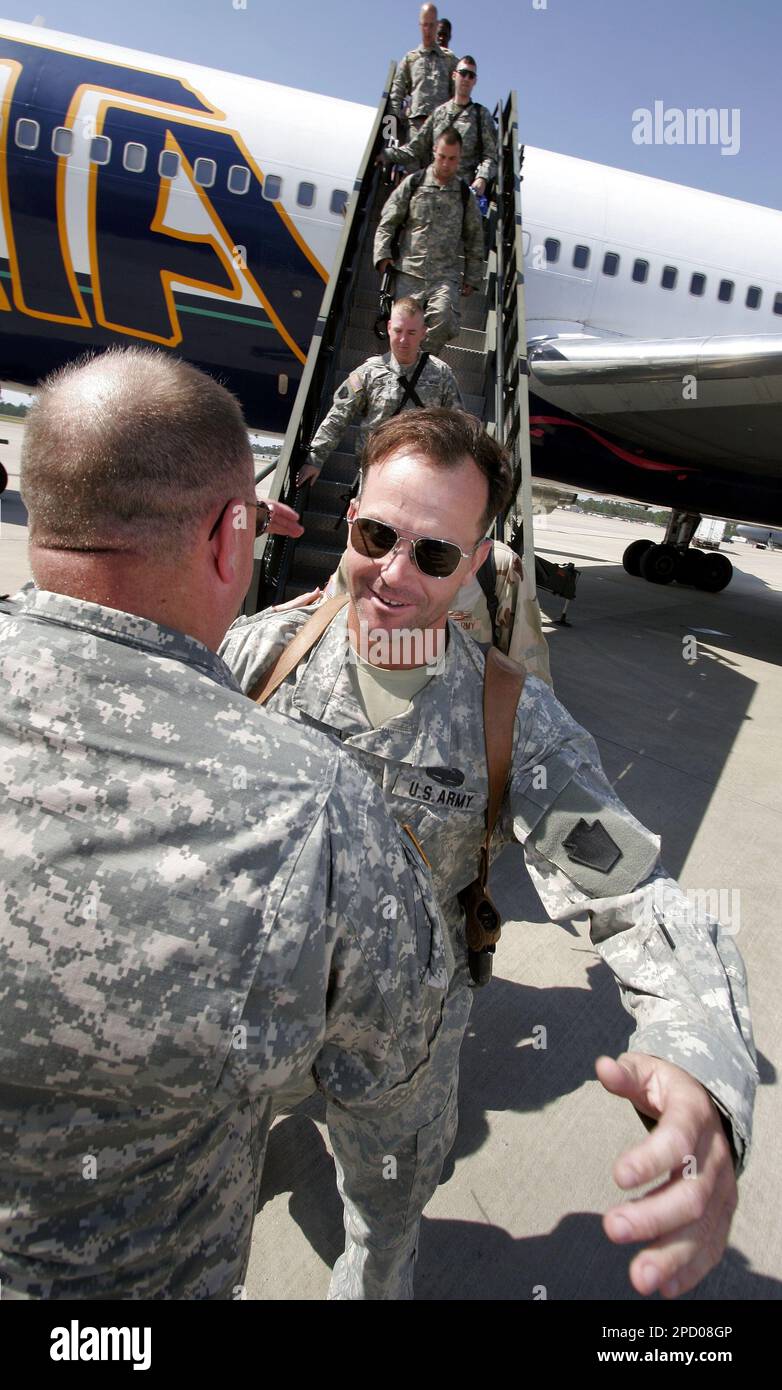 1st Lt. Anselm Richards, right, embraces Command Sgt. Major Don Shiner ...