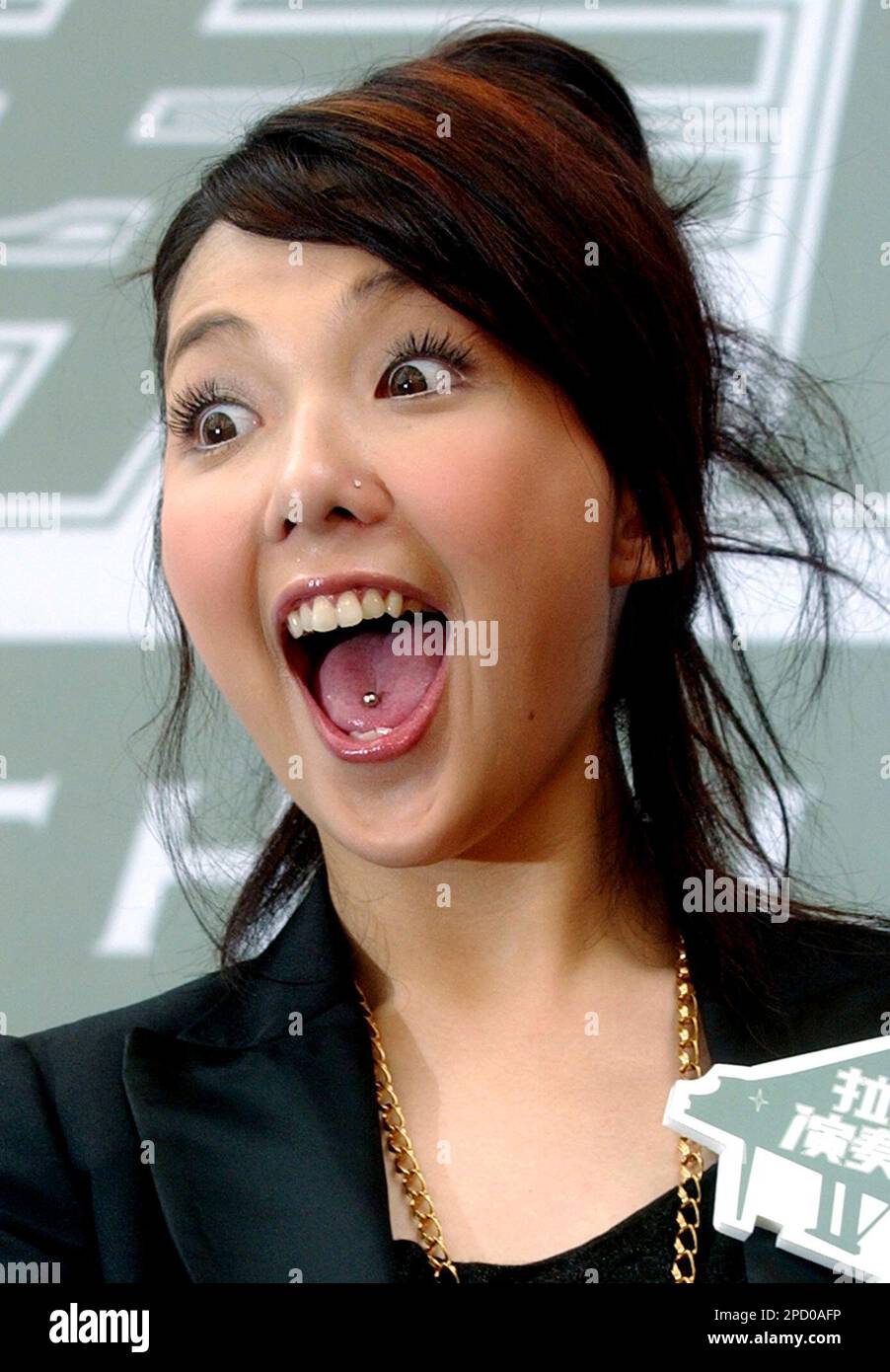 A tongue ring is seen on her tongue as Hong Kong actress-singer Janice ...