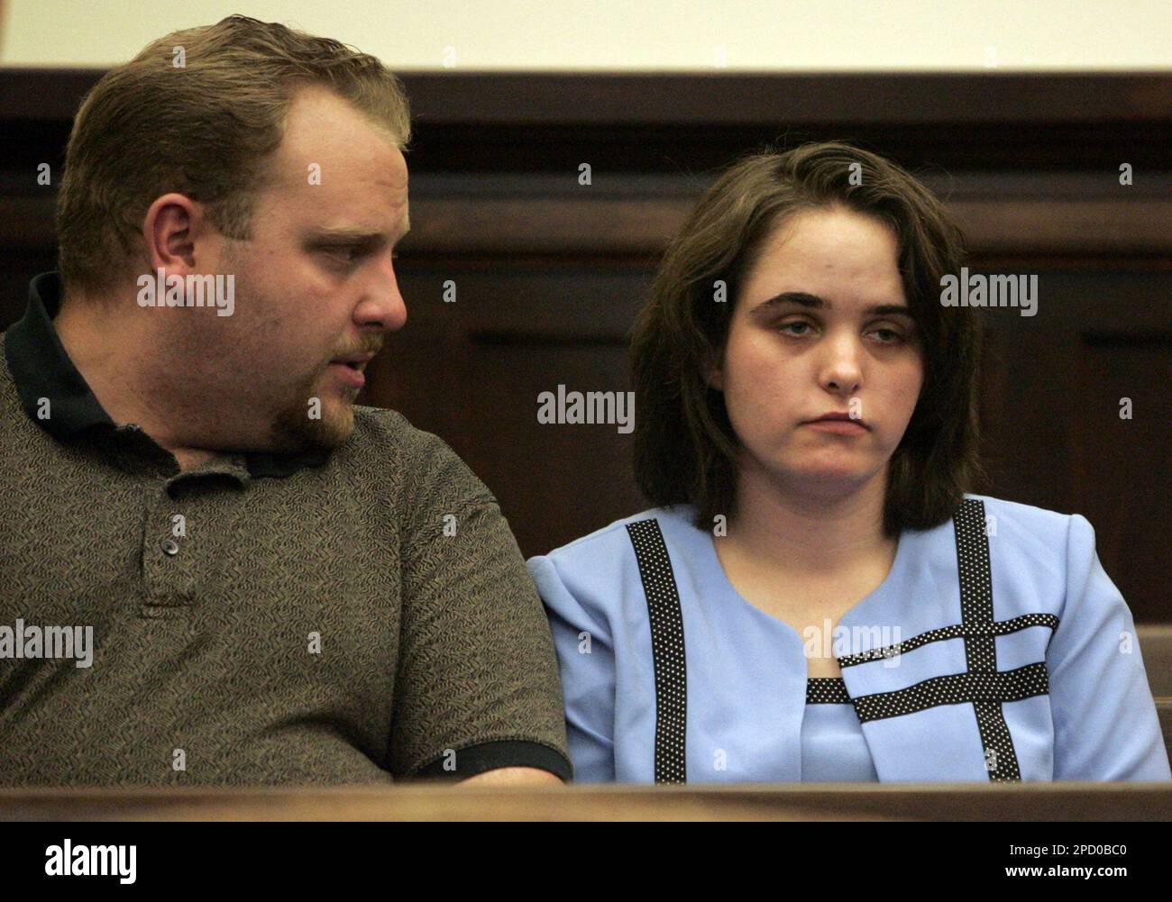 Greg Suchy, left, whispers to his fiancee, Shenna Grimm, as they listen ...